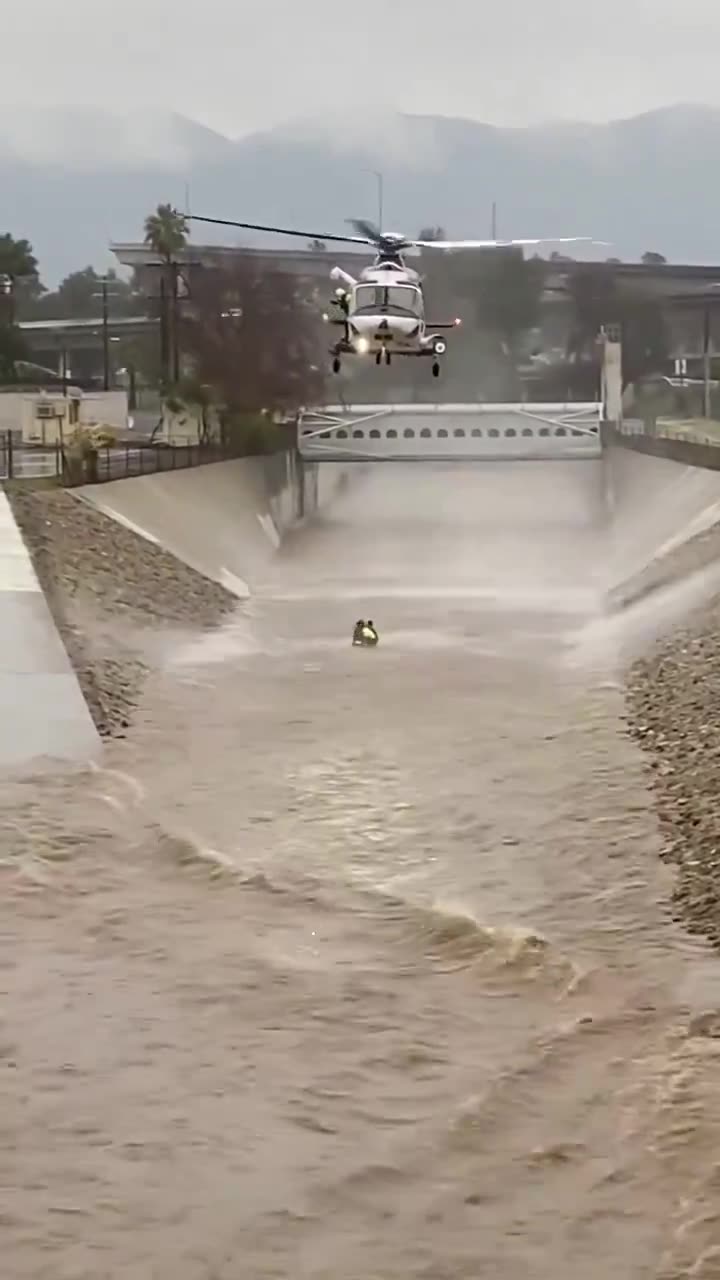 LA firefighter dangling from helicopter rescues a man