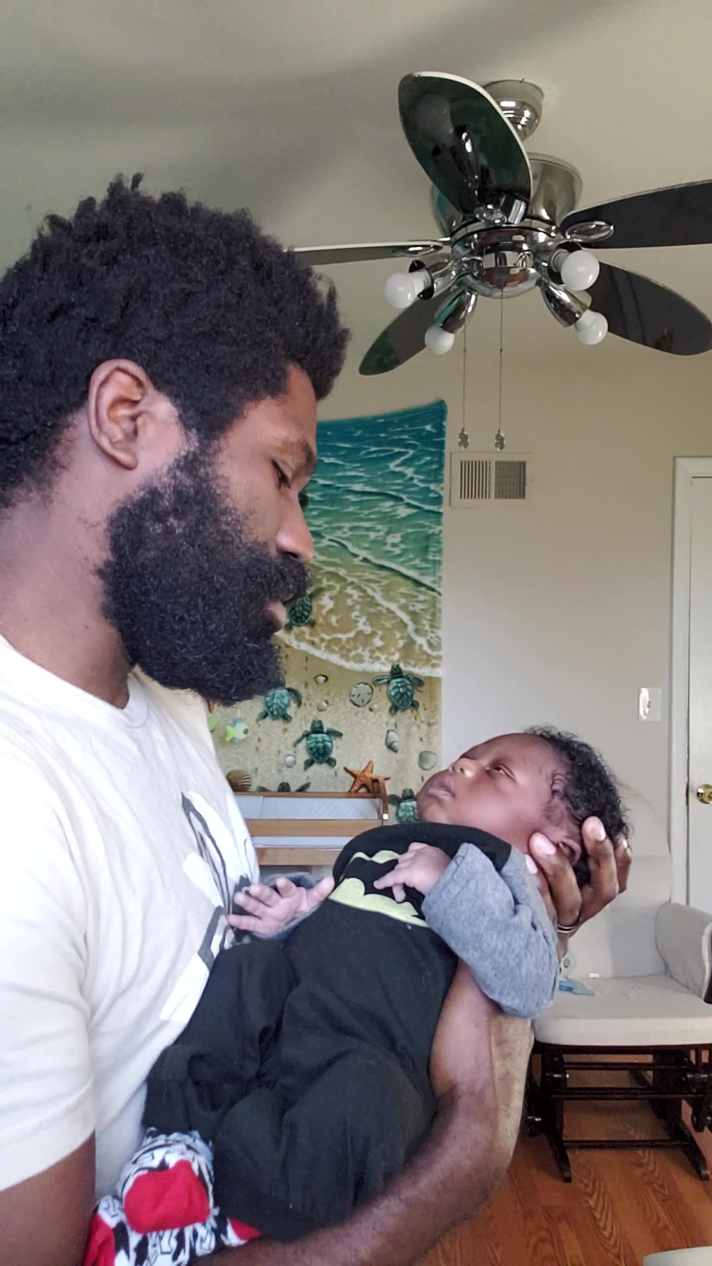Loving dad sings and dances with his newborn baby