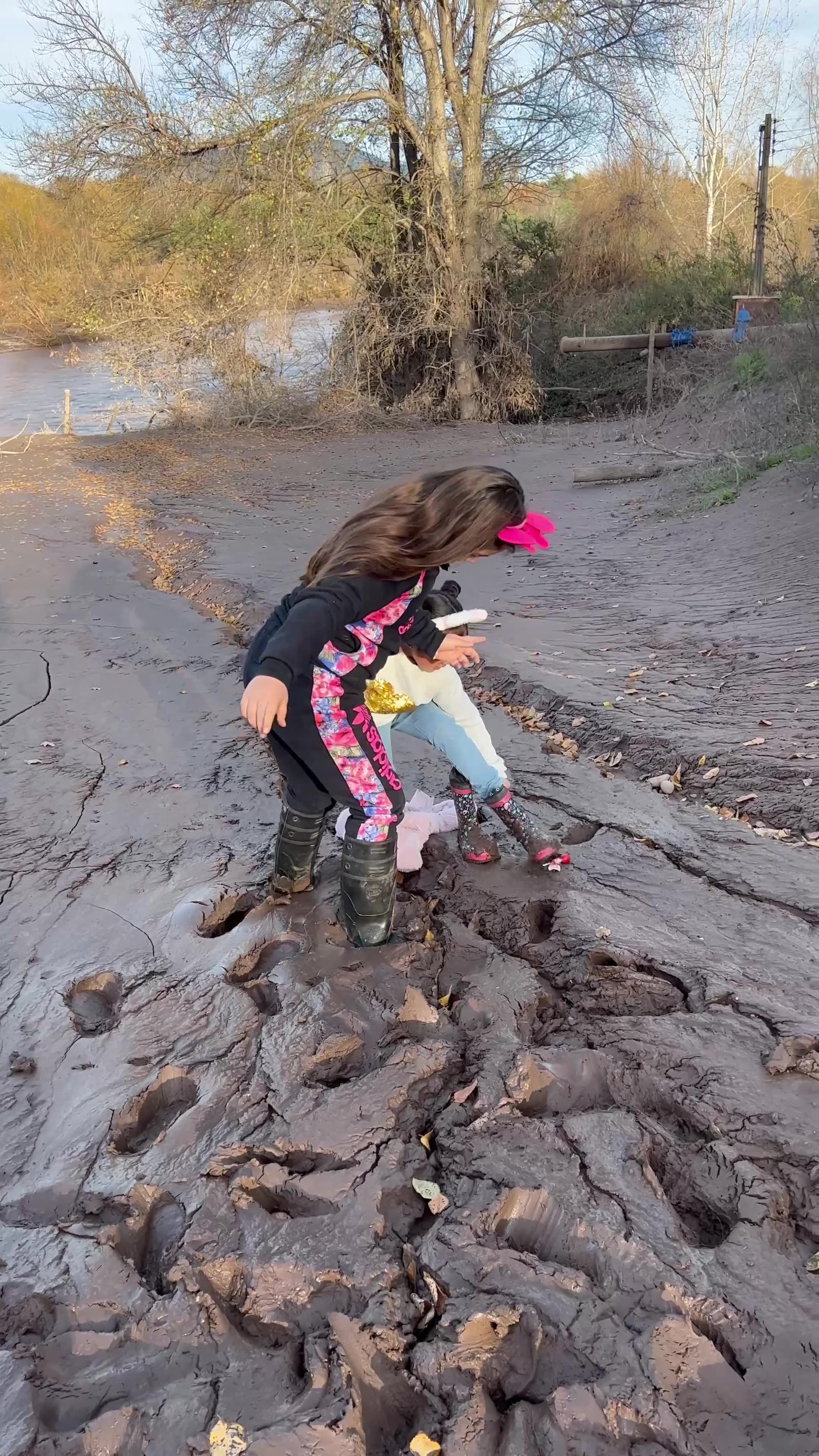 Muddy Riverbank Causes Family Mess