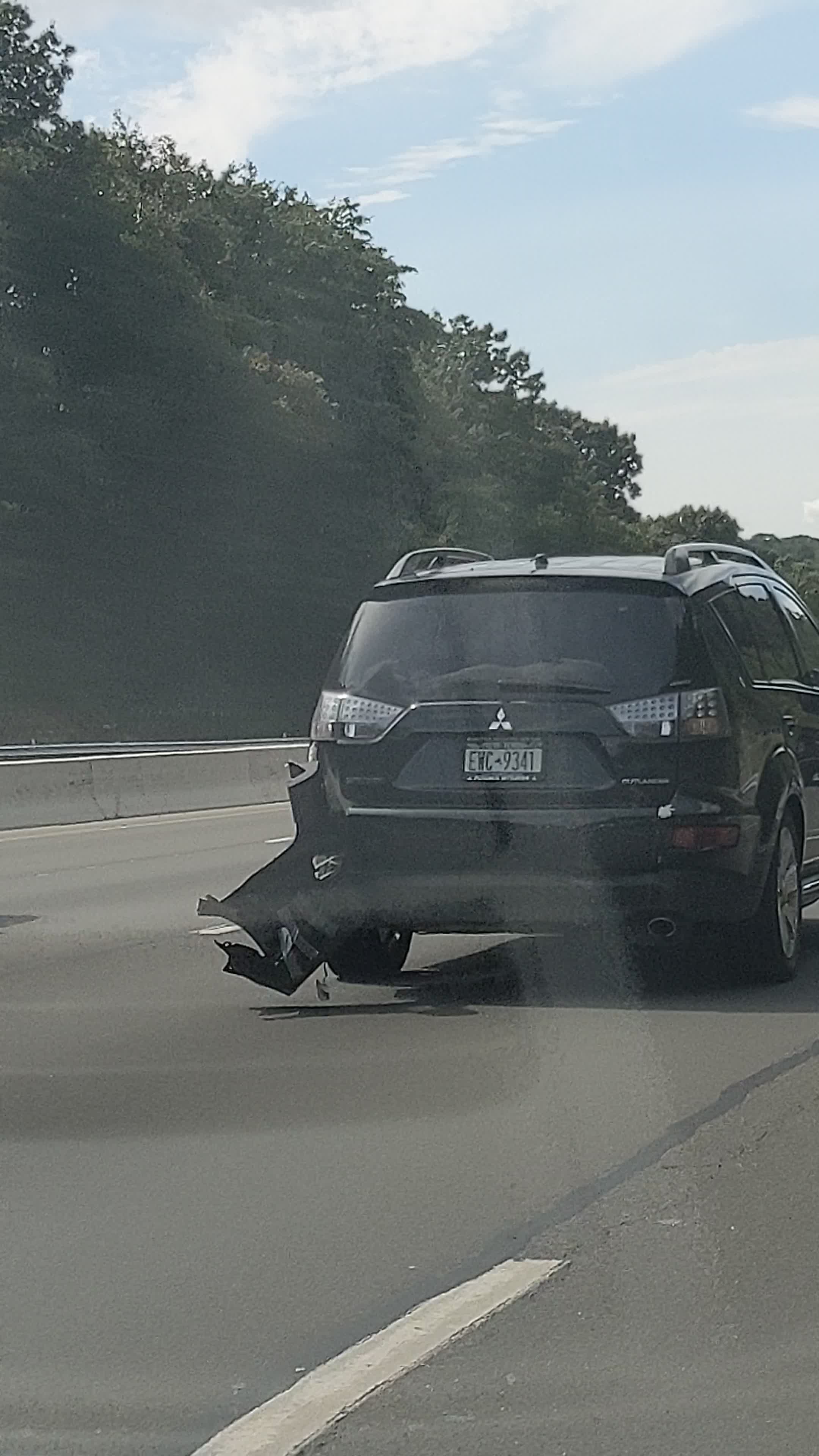 Car bumper hanging on the road